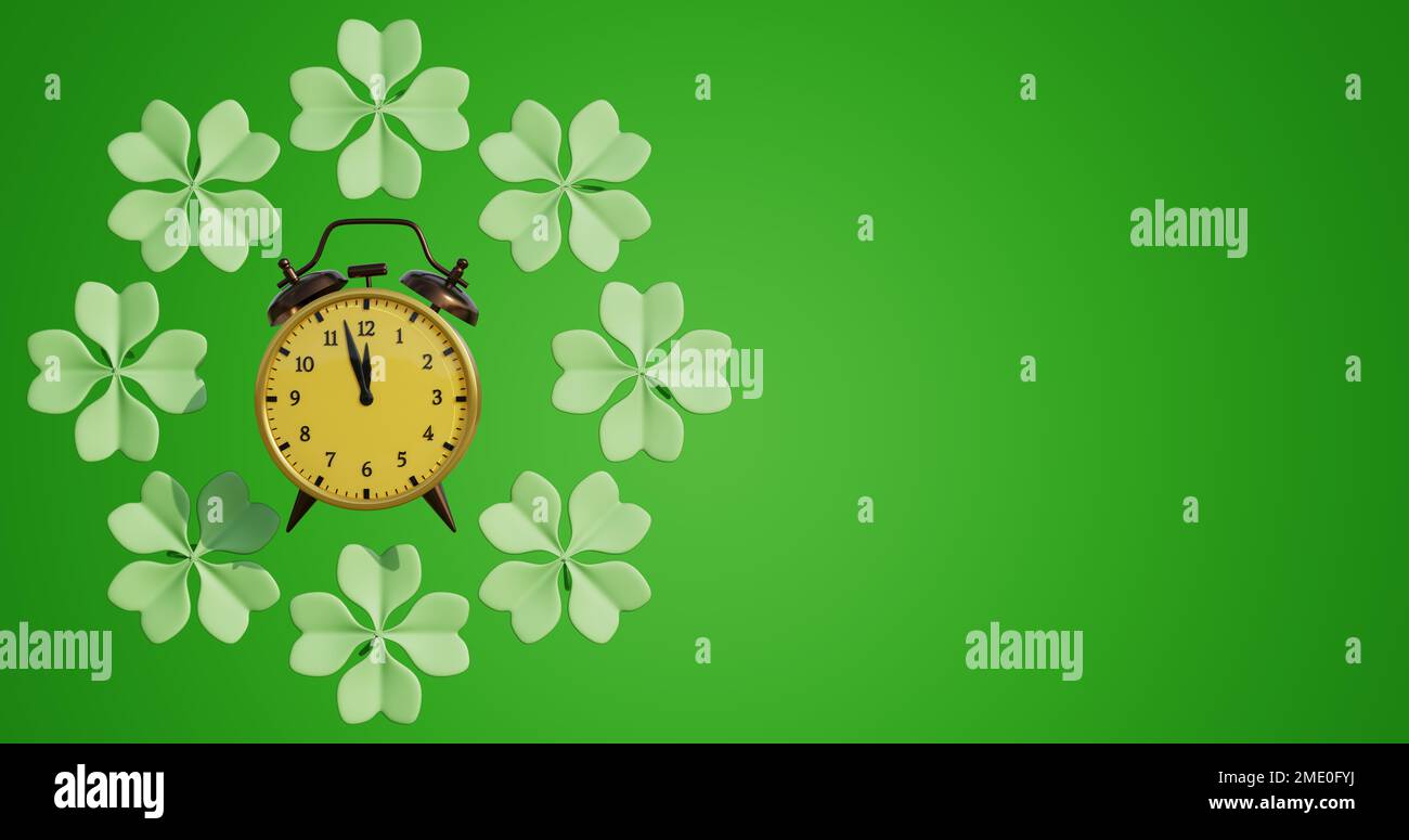 Saint Patrick's Day. Alarm clock surrounded by clover leaves on a green ...