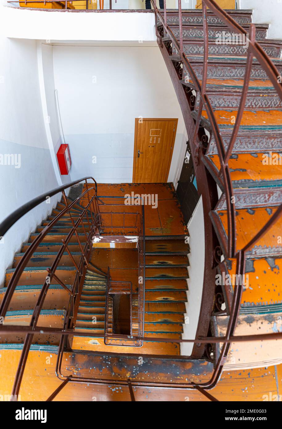 Look down to old high square spiral stairscase in old tenement building ...