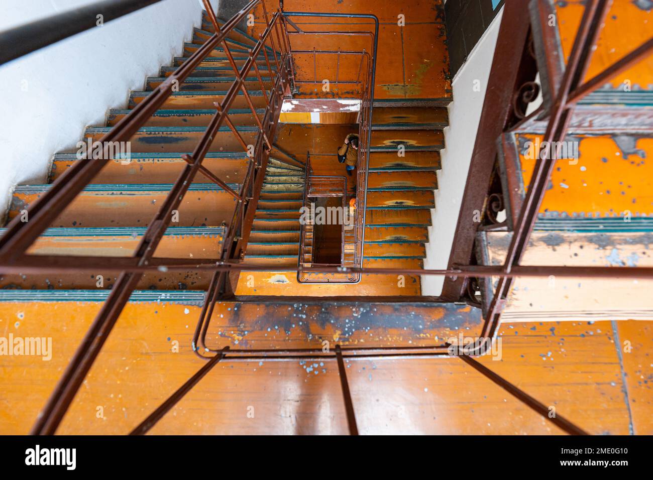 Look down to old high square spiral stairscase in old tenement building ...