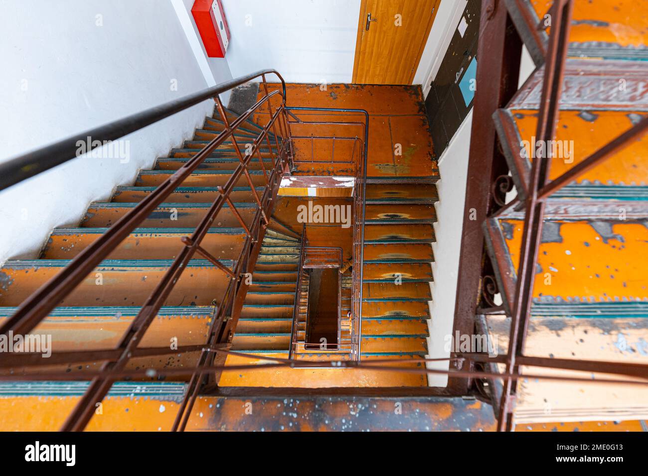 Look down to old high square spiral stairscase in old tenement building ...