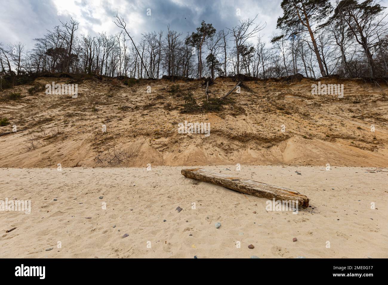 Looking up to high sandy and stony cliff next to the beach Stock Photo ...