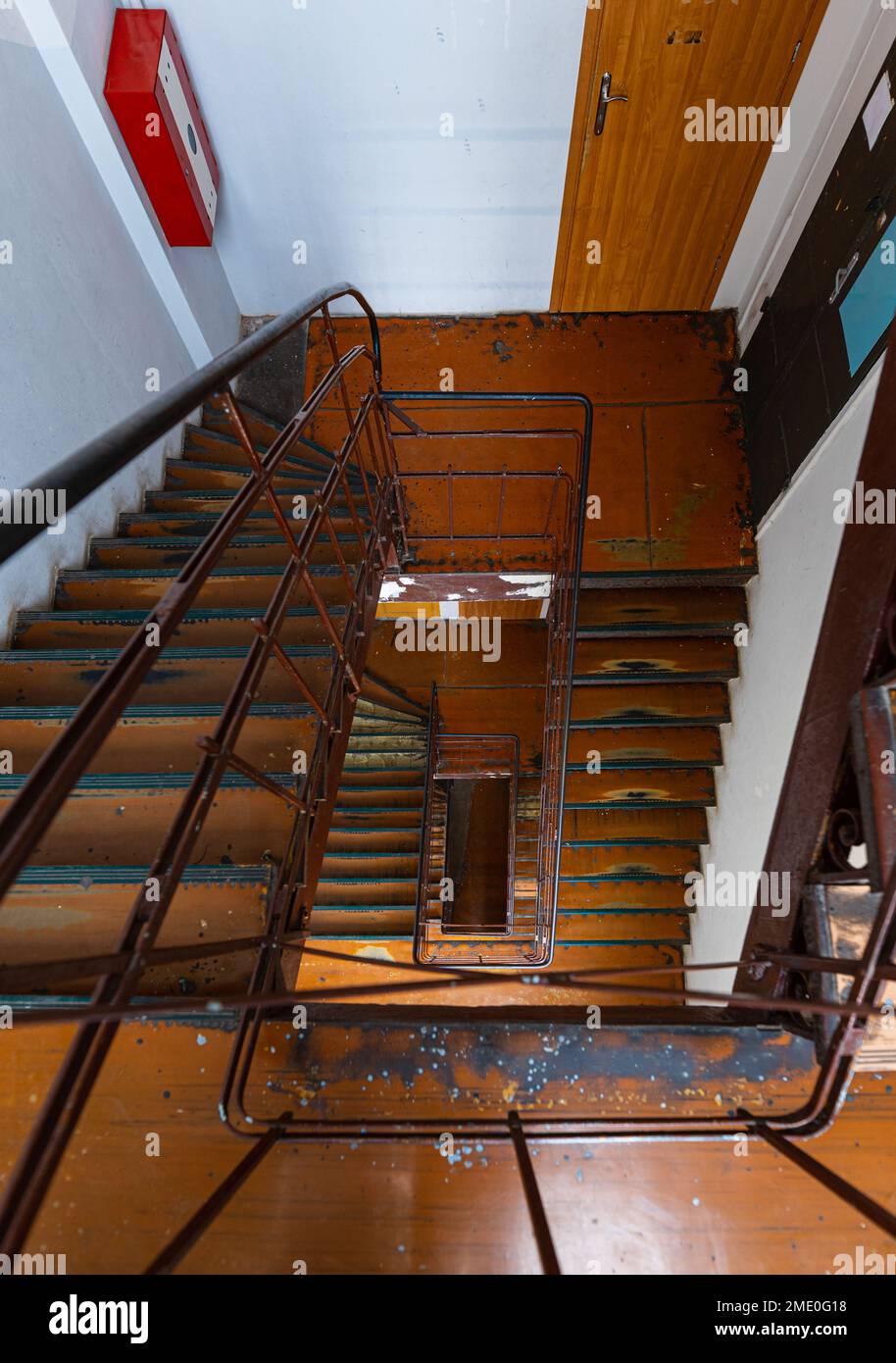 Look down to old high square spiral stairscase in old tenement building ...