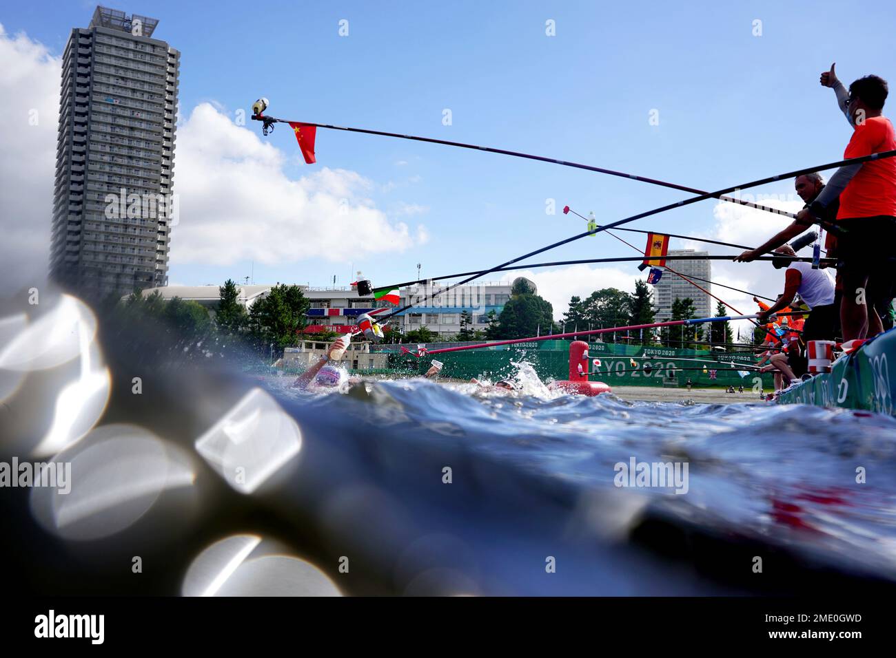 Swimmers pass through a feeding station during the women's marathon ...
