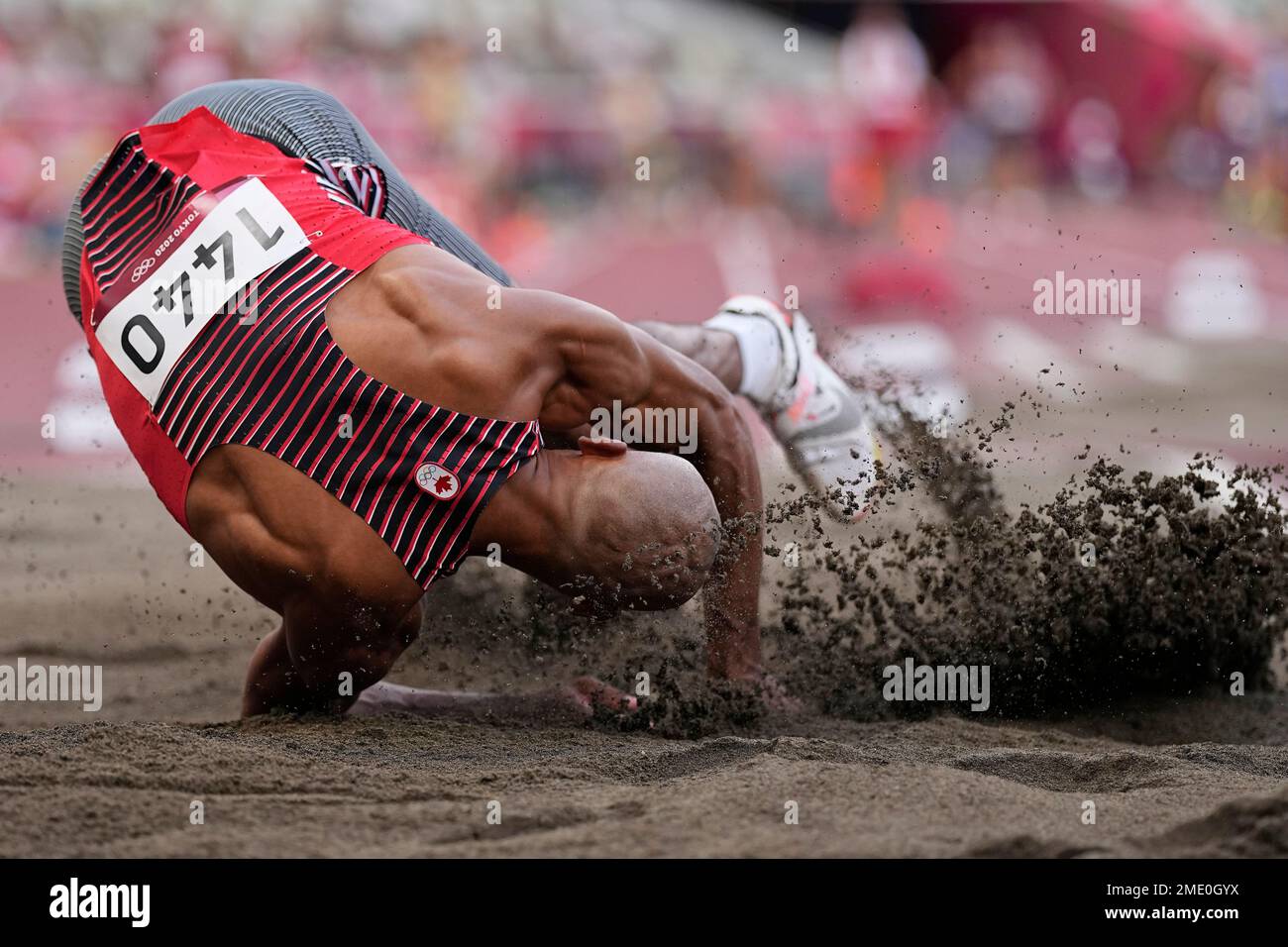 Damian Warner, of Canada, falls in the long jump of the decathlon at ...