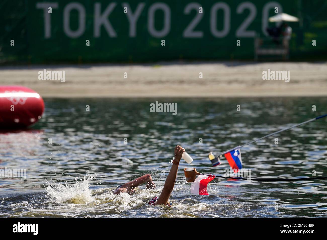 Chantal Liew, of Singapore, grabs a drink at a feeding station during ...