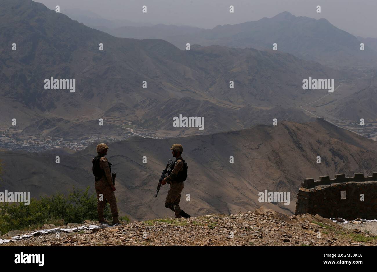 Pakistan Army troops observe the area from a hilltop post on the ...