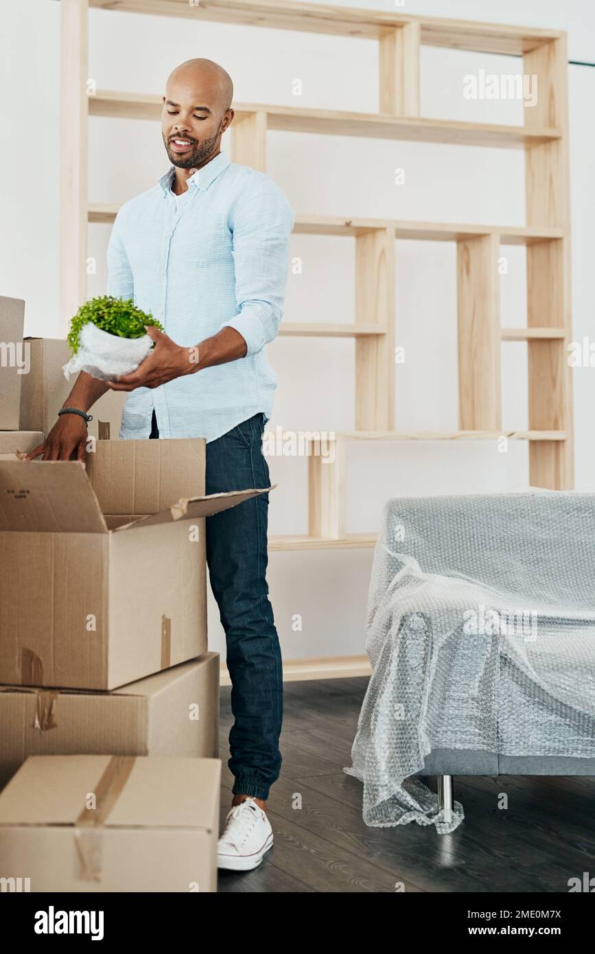Everything will have a new place in this home. a young man unpacking ...