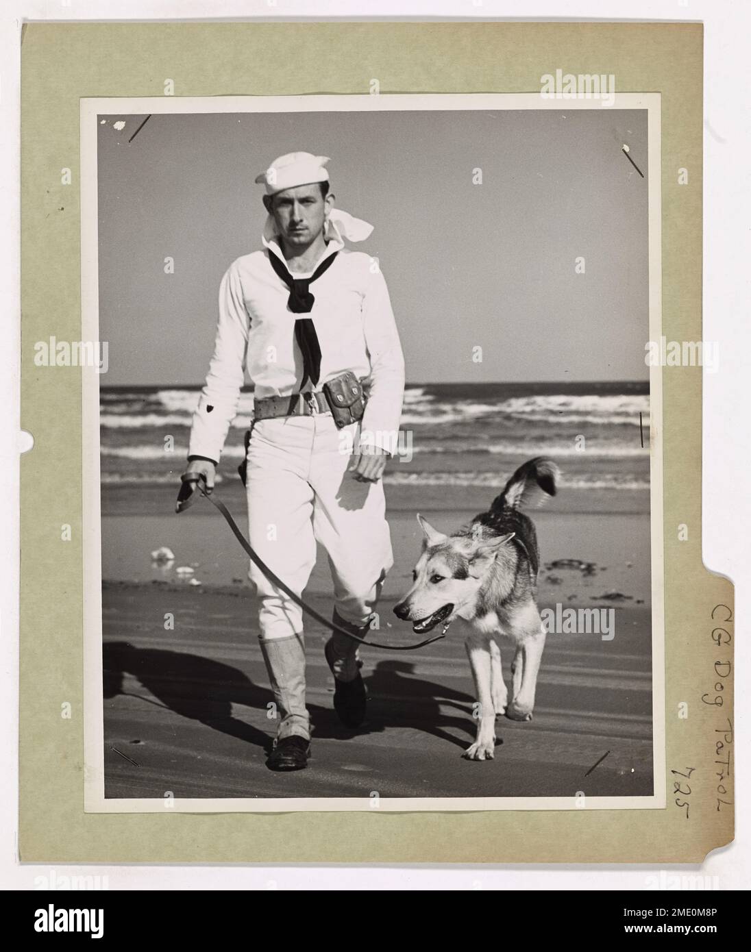 A Coast Guardsman and his working dog patrol a quiet stretch of ...