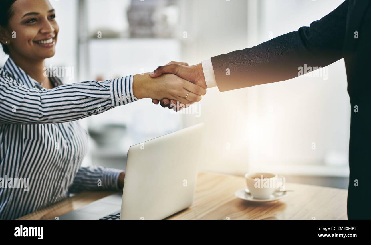 Lets talk business. two businesspeople shaking hands in an office Stock ...