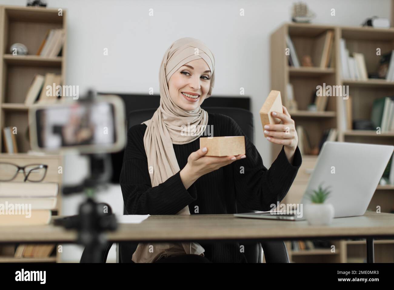 Happy muslim female blogger unpacking gift boxes presents from ...