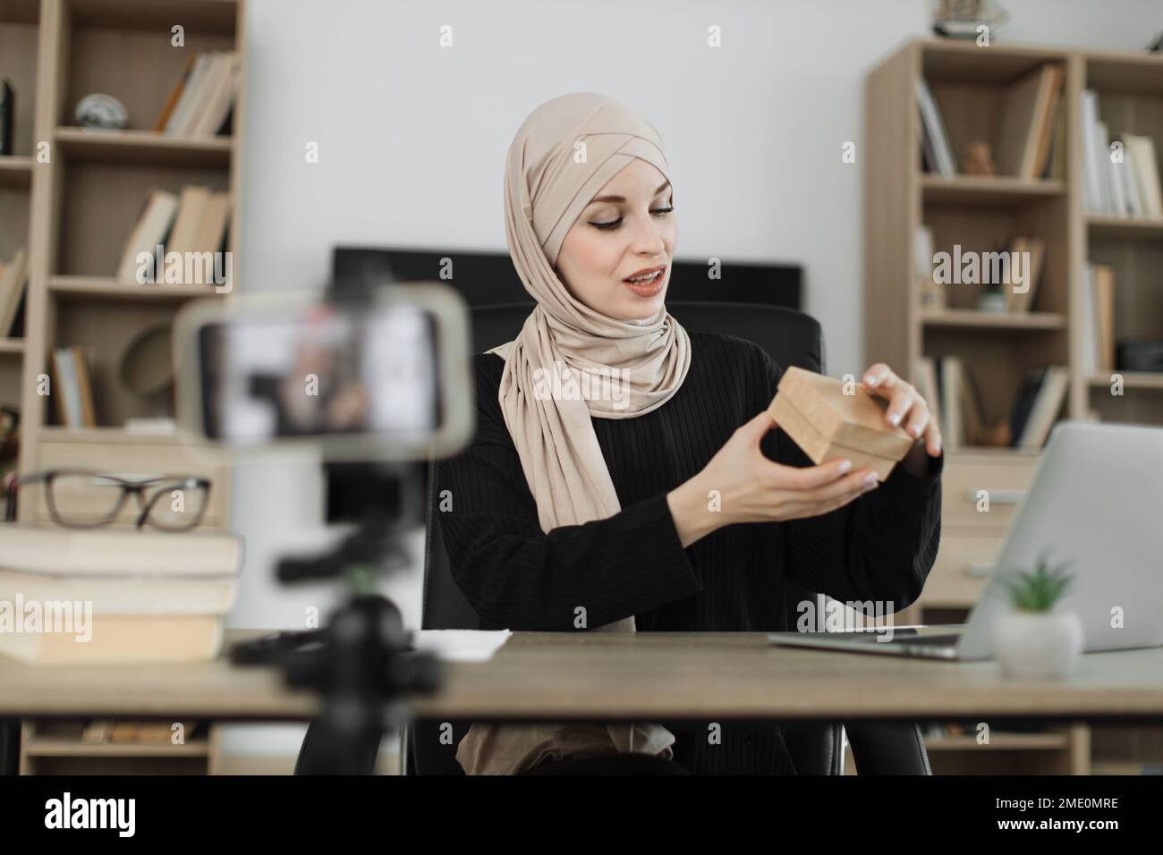 Happy muslim female blogger unpacking gift boxes presents from ...