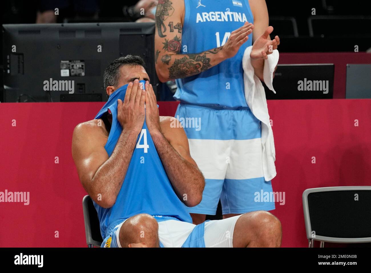 Argentina's Luis Scola (4) pulls his jersey over his face as he ...