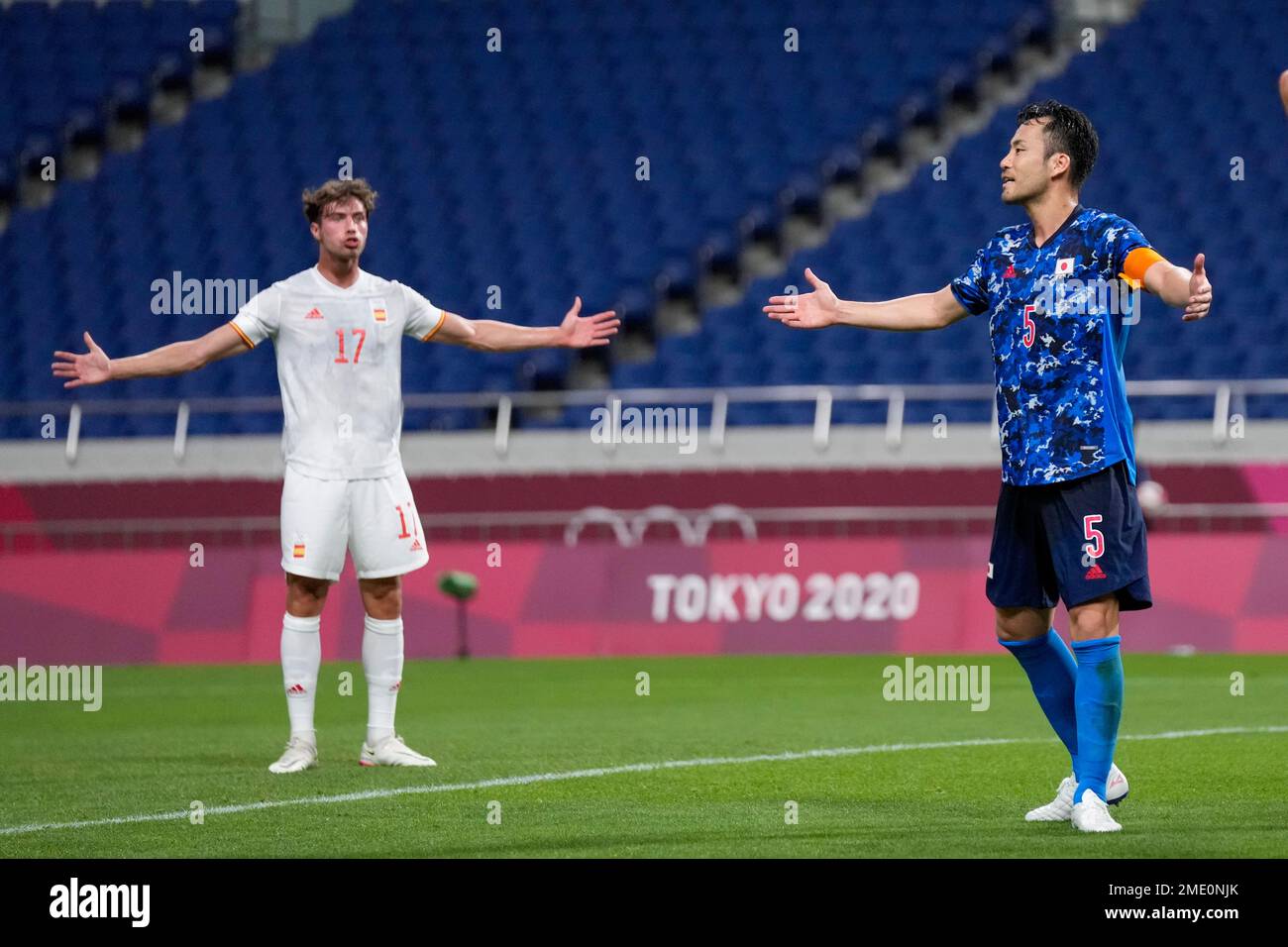 Japan's Maya Yoshida (5) and Spain's Javier Puado gesture in a men's ...