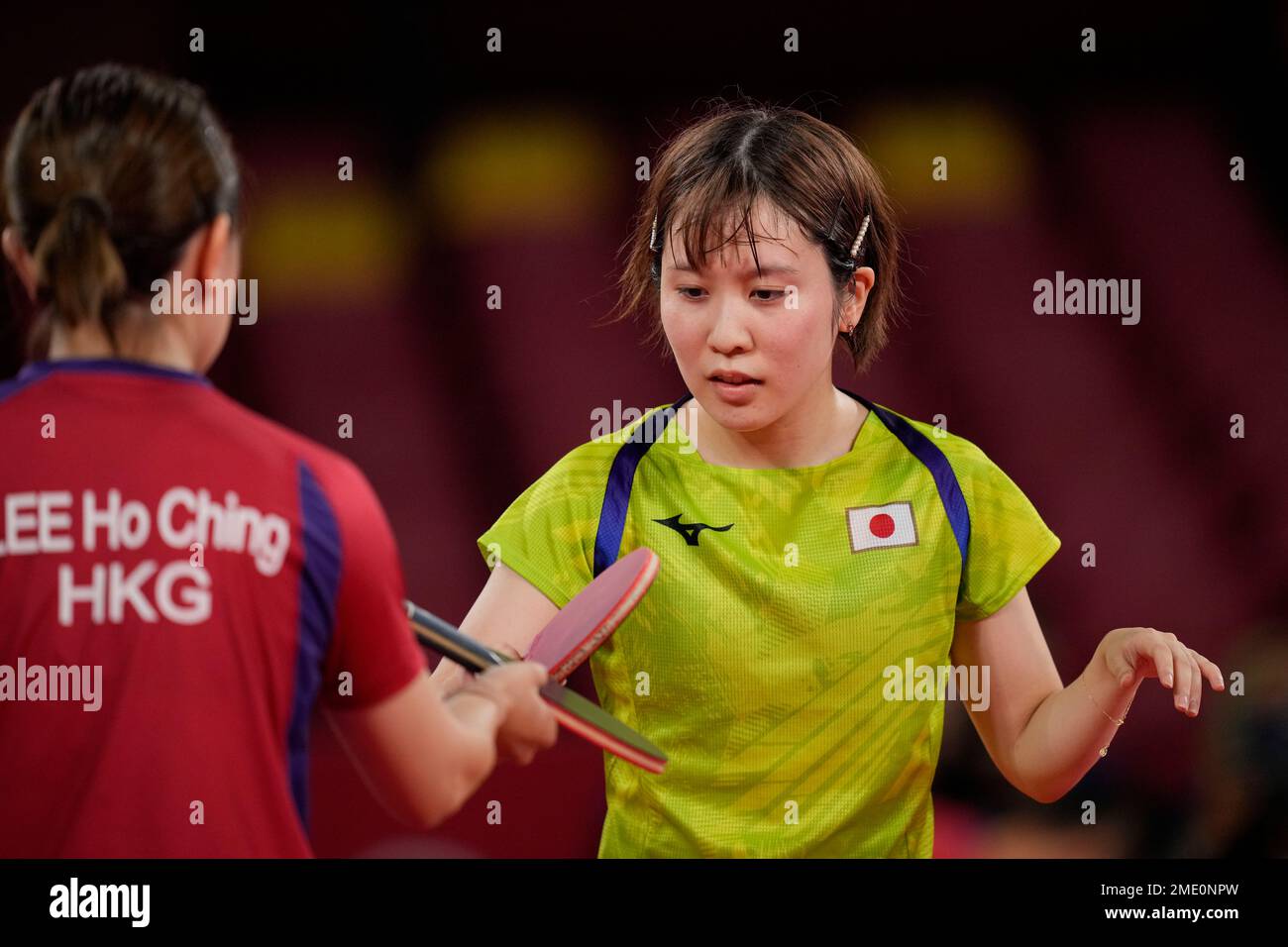 Japan's Miu Hirano claps paddles with Hong Kong's Lee Ho-ching after ...