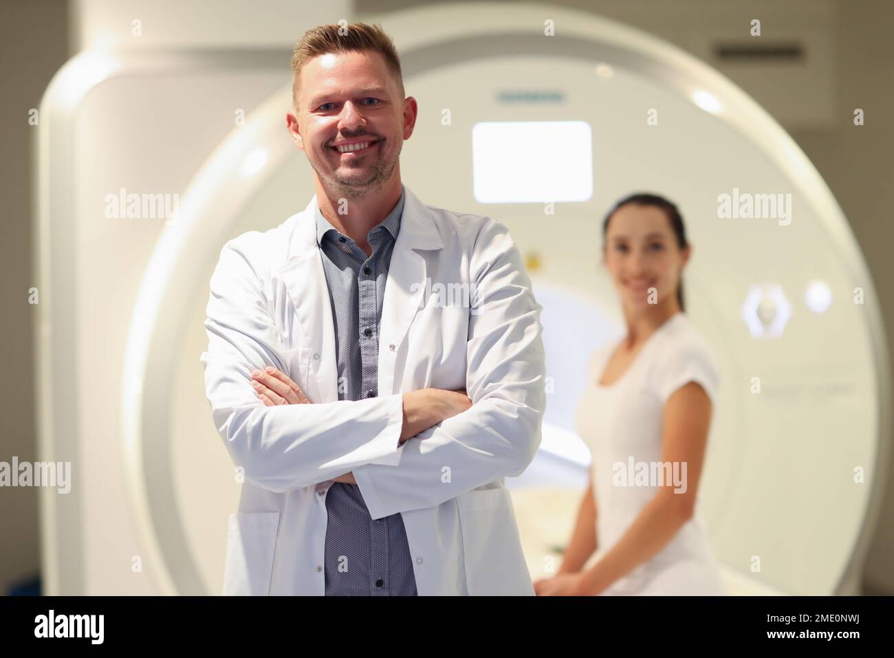 Confident smiling male doctor close-up and female patient and CT ...