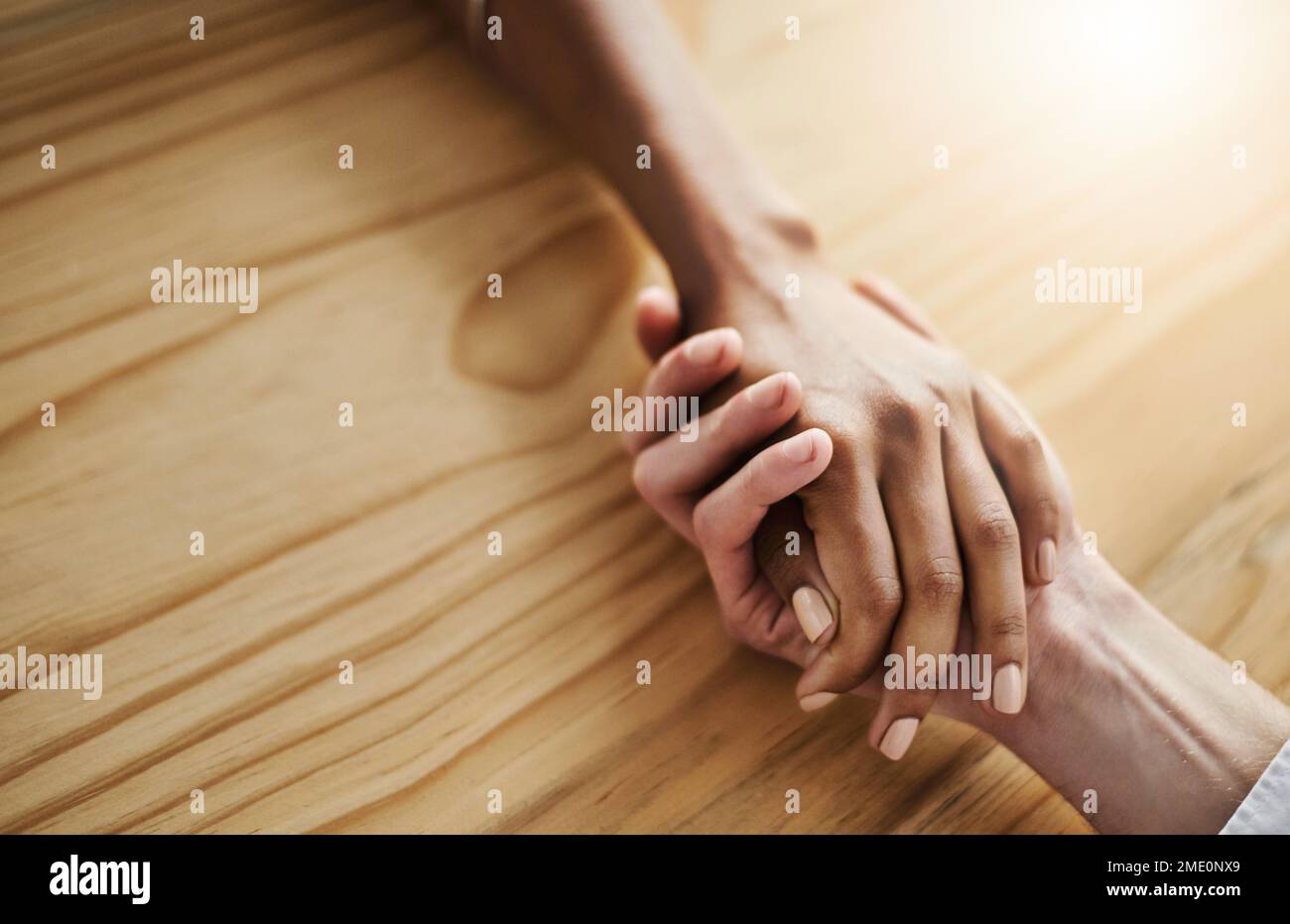 Show a little care. Closeup shot of two people holding hands in comfort ...