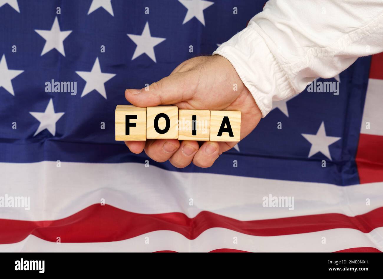 Business concept. Against the background of the USA flag, a man's hand ...