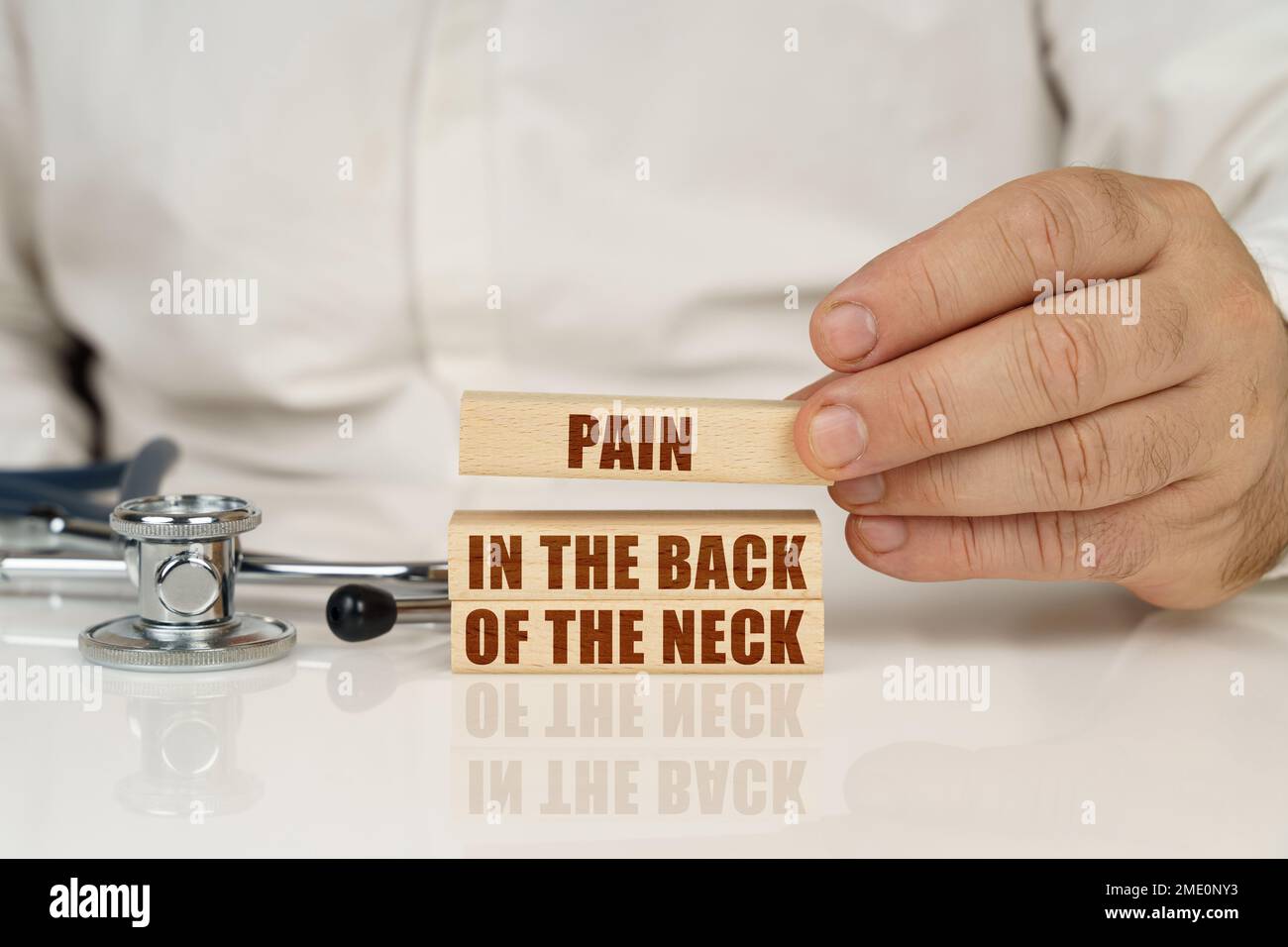 Medical concept. On a white surface, a stethoscope and wooden plates ...