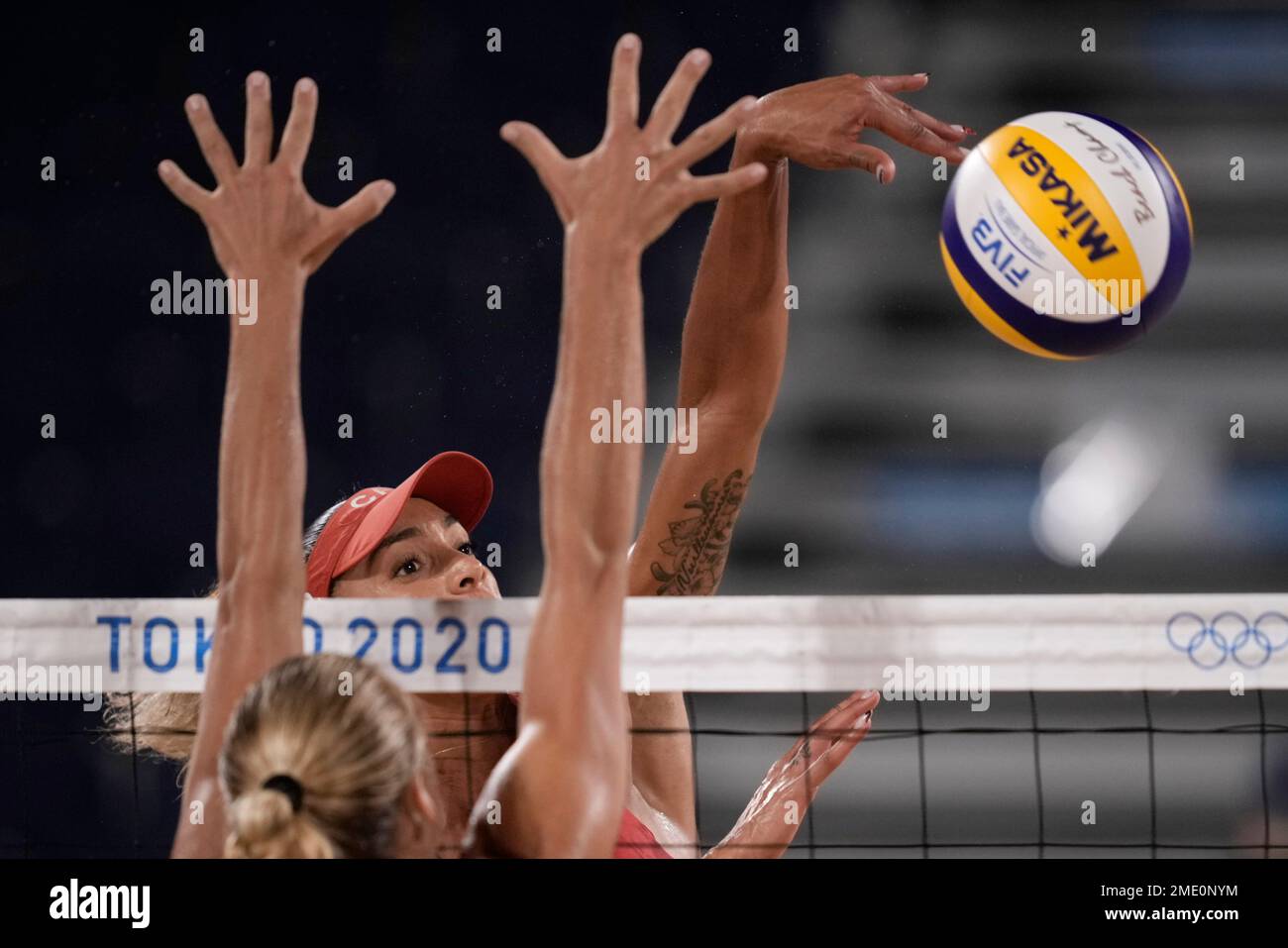 Brandie Wilkerson, top, of Canada,gets a shot past the defense of Tina ...