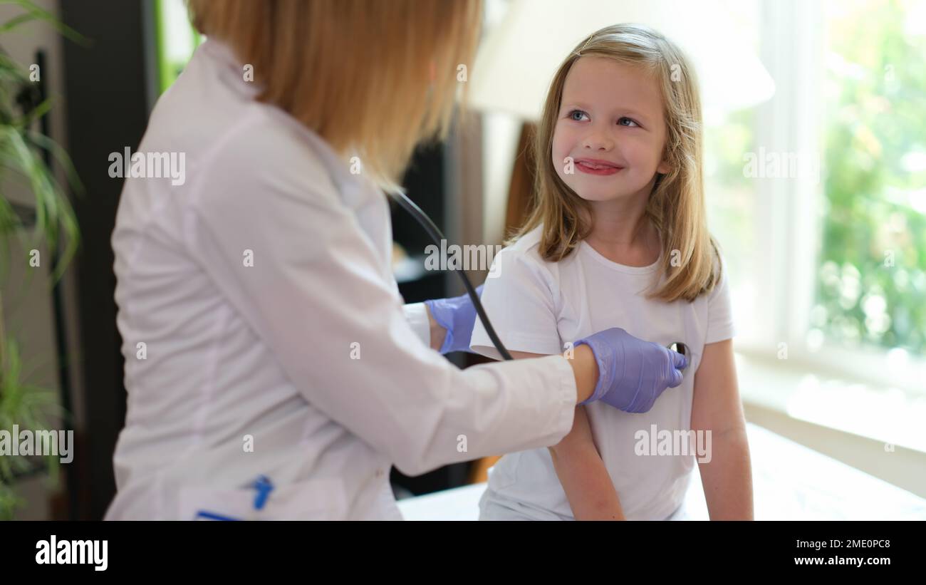 Young female patient smiles at doctor at medical examination Stock ...