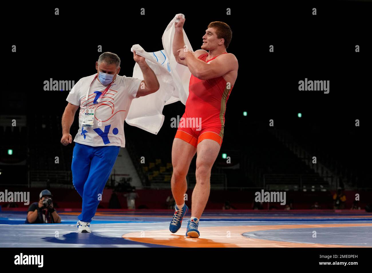 Russian Olympic Committee's Evloev Musa, right, celebrates defeating ...