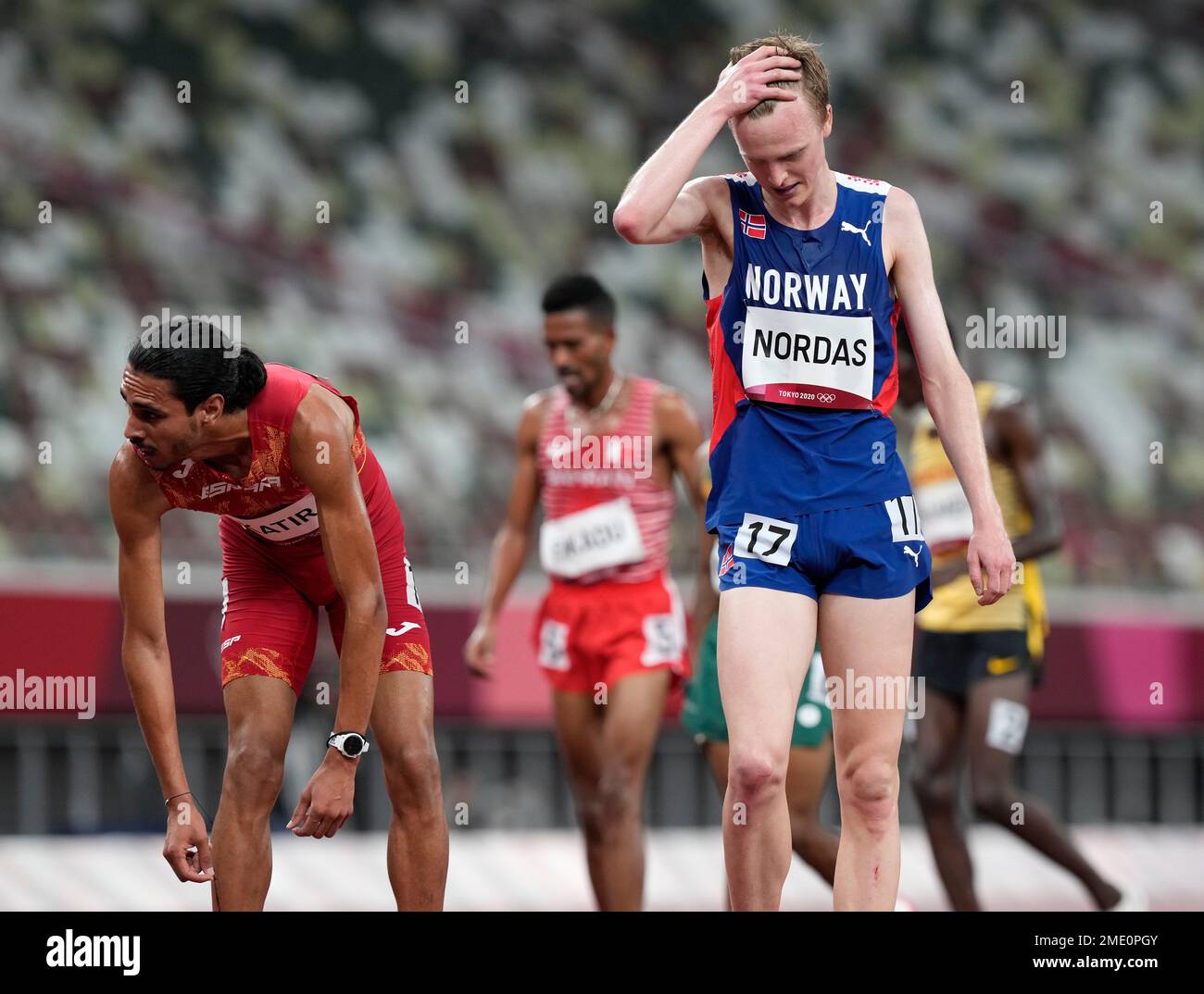Narve Nordas, of Norway reacts after finishing a men's 5,000-meter heat ...