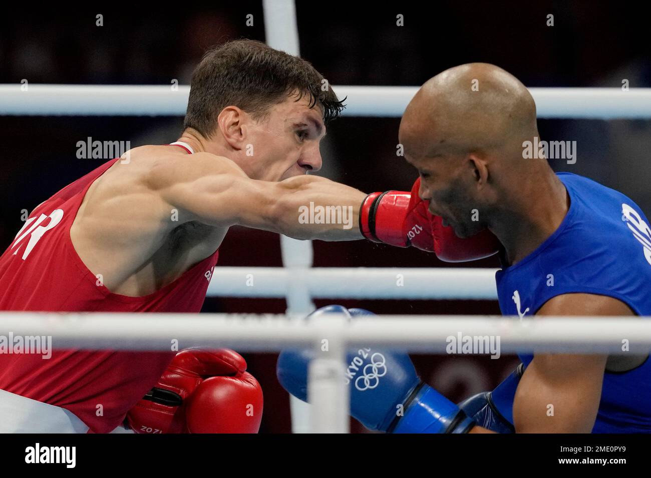 Britain's Pat McCormack, left, exchanges punches with Cuba's Roniel ...