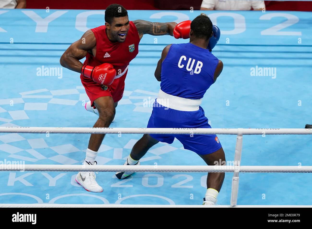 Brazil's Abner Teixeira, left, exchanges punches with Cuba's Julio la ...