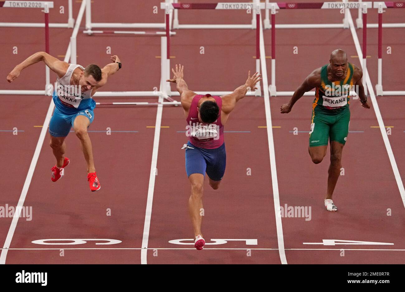 Devon Allen, of United States, center, competes alongside Elmo Lakka ...
