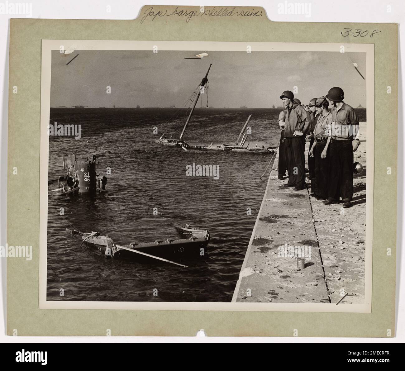 Coast Guard coxswains and boat crews inspect a wrecked Japanese landing ...