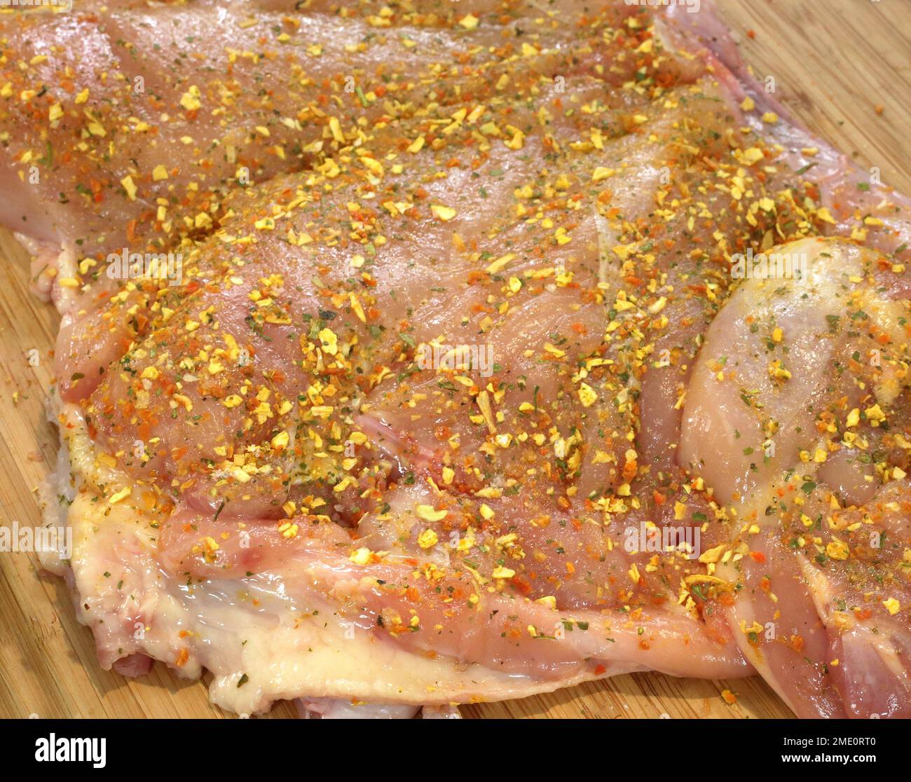 Raw boneless chicken fillet seasoned with dried vegatebles mix Stock ...