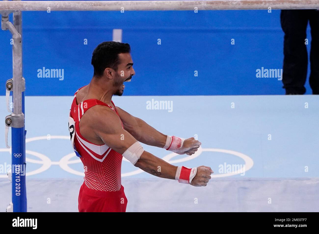 Ferhat Arican, of Turkey, finishes performing on the parallel bars ...