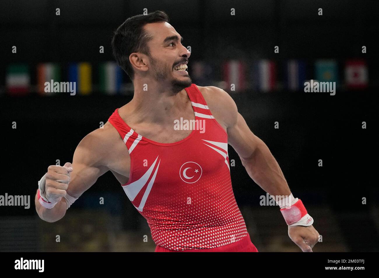 Ferhat Arican, of Turkey, finishes on the parallel bars during the ...
