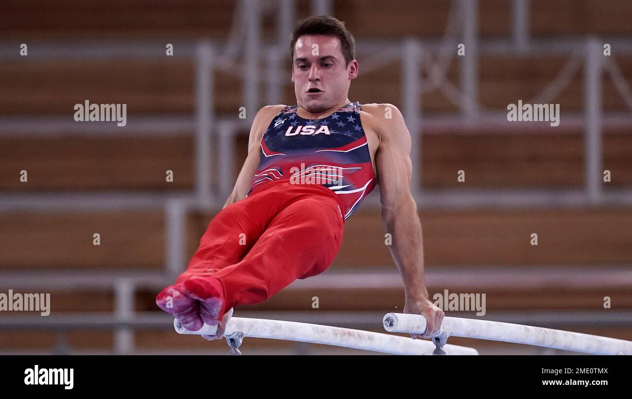 Samuel Mikulak, of the United States, performs on the parallel bars ...