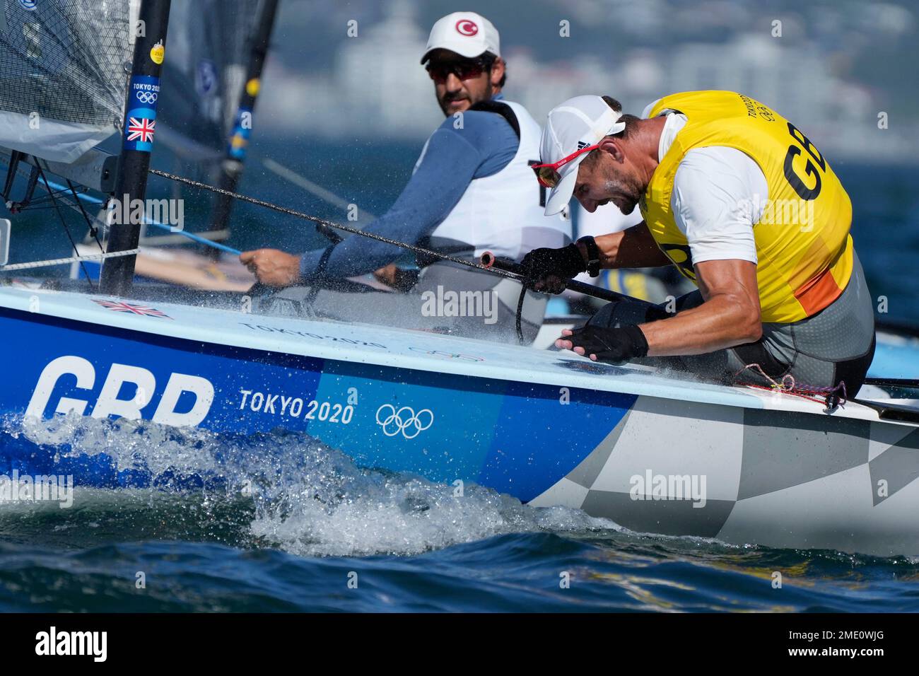 Britain's Giles Scott, right, celebrates placing first in the men's ...