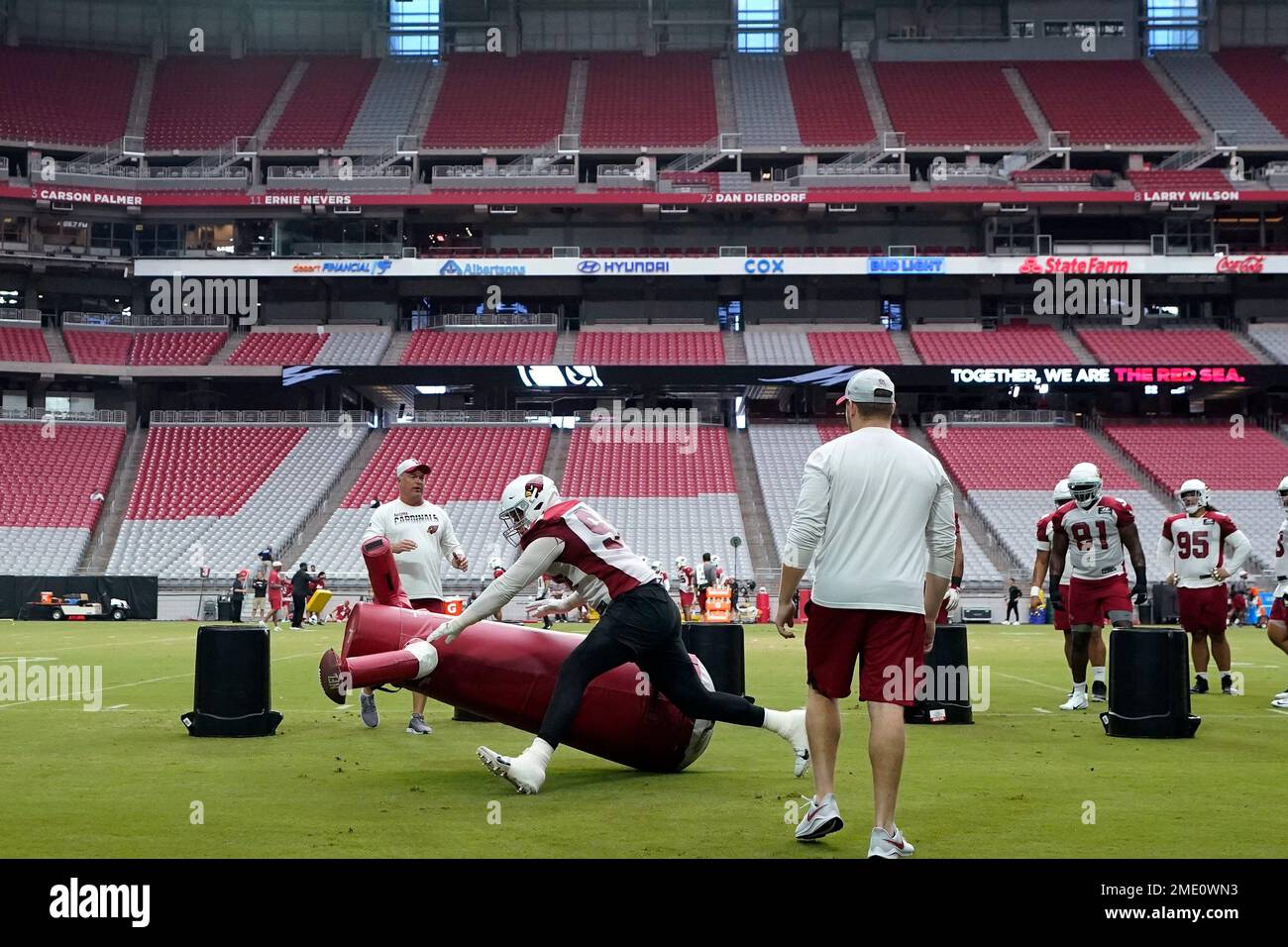 Arizona Cardinals defensive end Zach Allen hits the tackling dummy during NFL football training ...