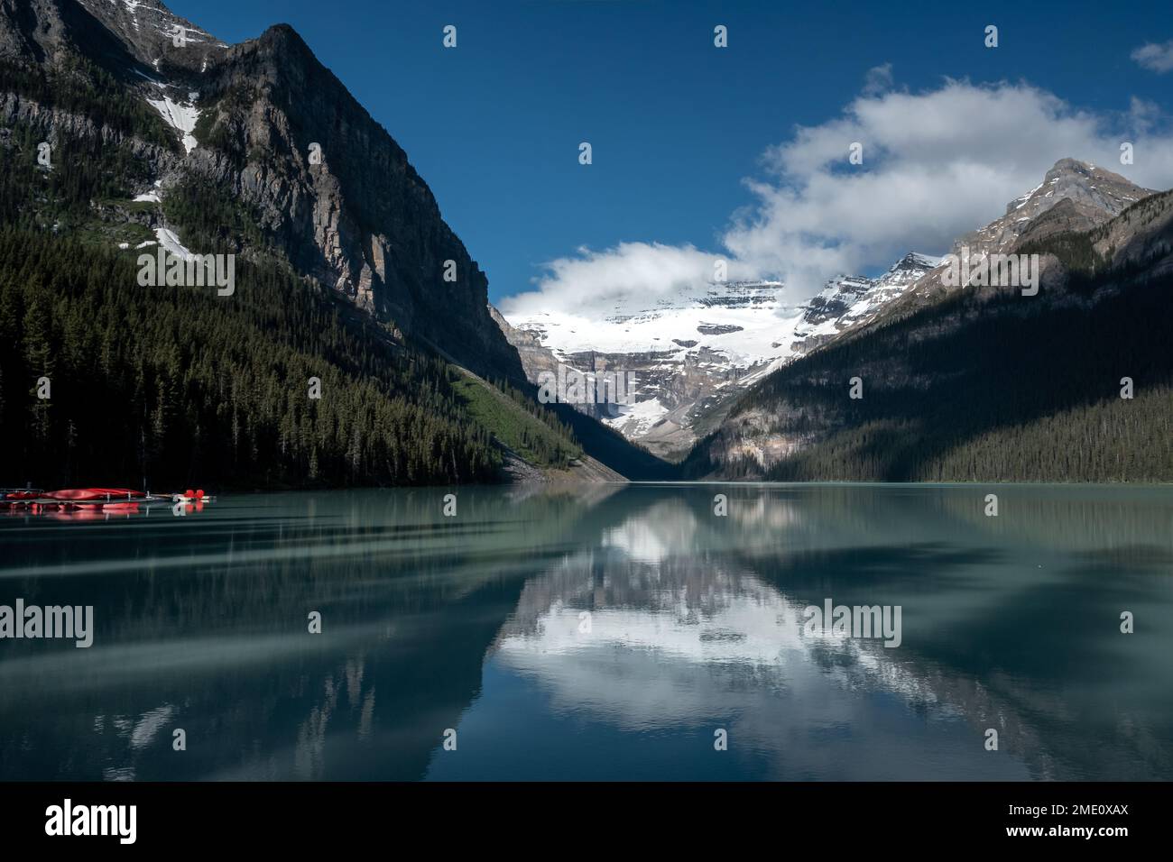 Mountain reflection on water of lake Louise in Canada Stock Photo - Alamy