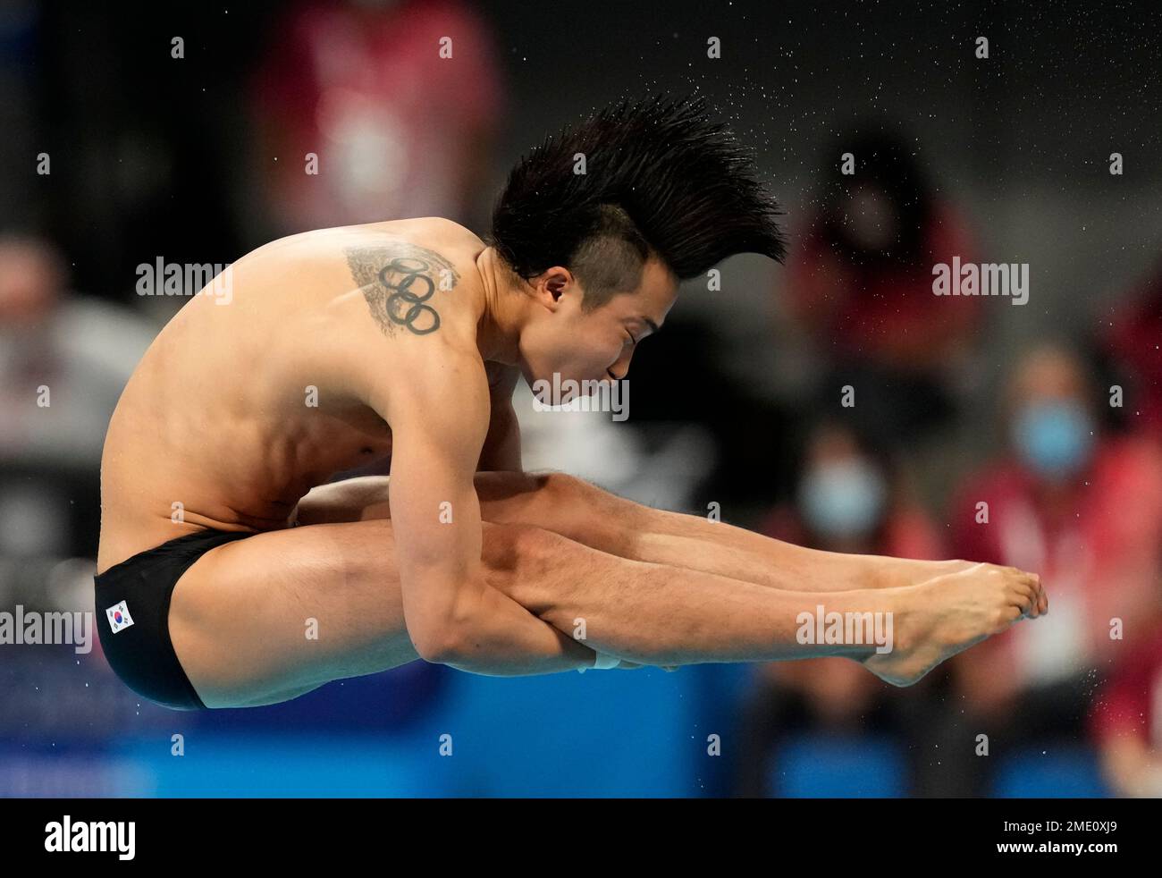 Haram Woo of South Korea competes in men's diving 3m springboard ...