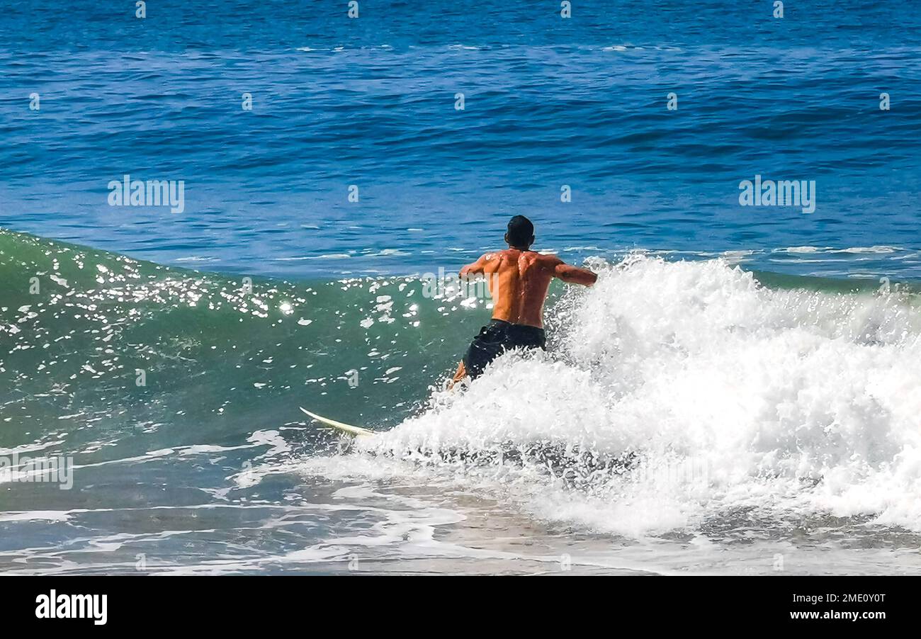 Surfer surfing on surfboard on high waves in Zicatela Puerto Escondido ...