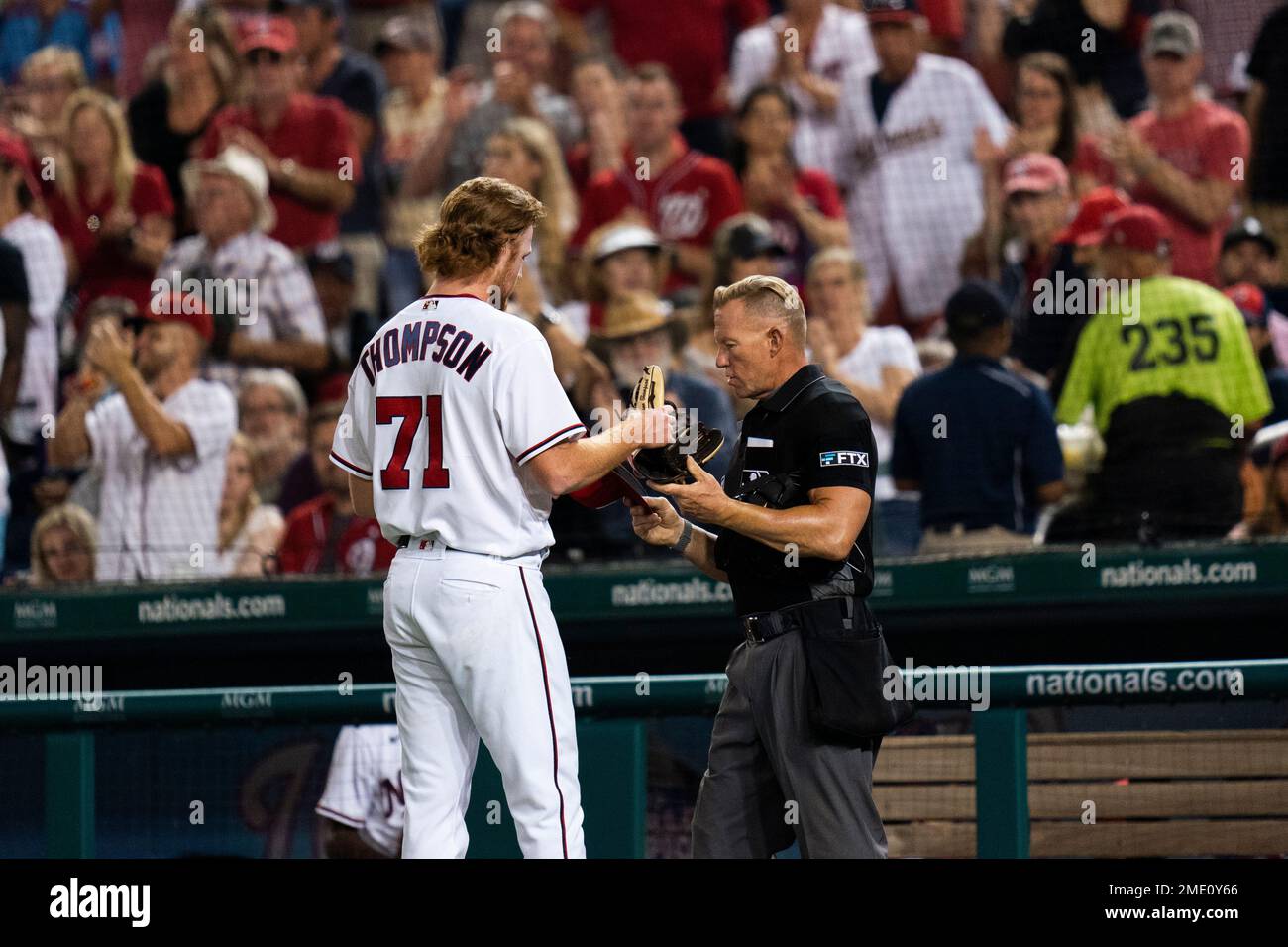 Home plate umpire checks Washington Nationals pitcher Mason Thompson's ...
