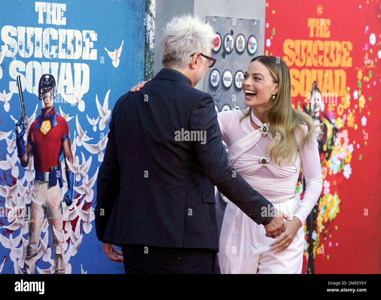 Margot Robbie, right, a cast member in "The Suicide Squad," greets the ...