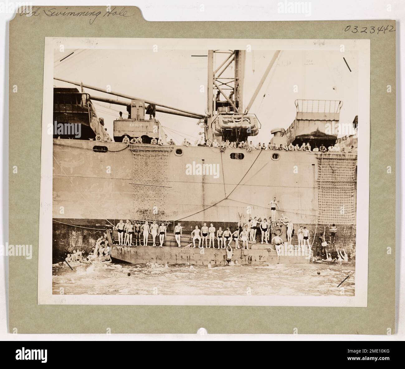 Coast Guardsmen and Marines take a break by swimming alongside a Coast ...