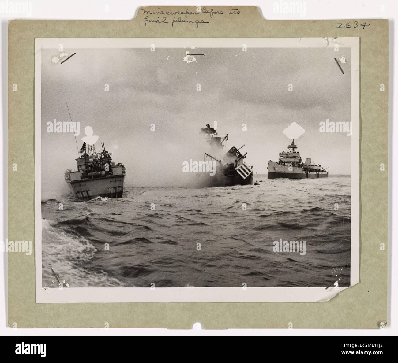 The USS Tide, a minesweeper, burns as it sinks off the coast of ...