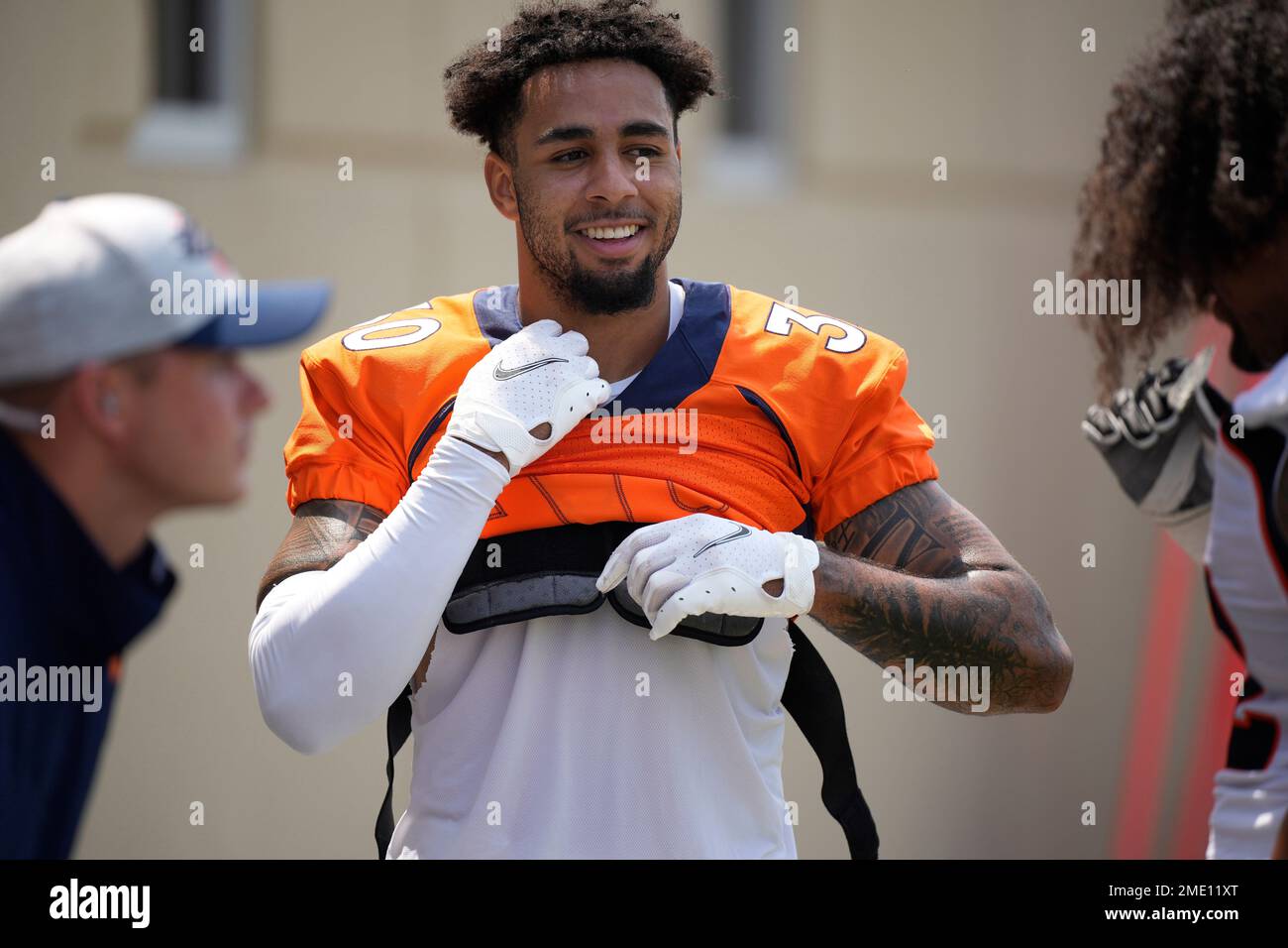Denver Broncos safety Caden Sterns takes off his jersey before entering ...