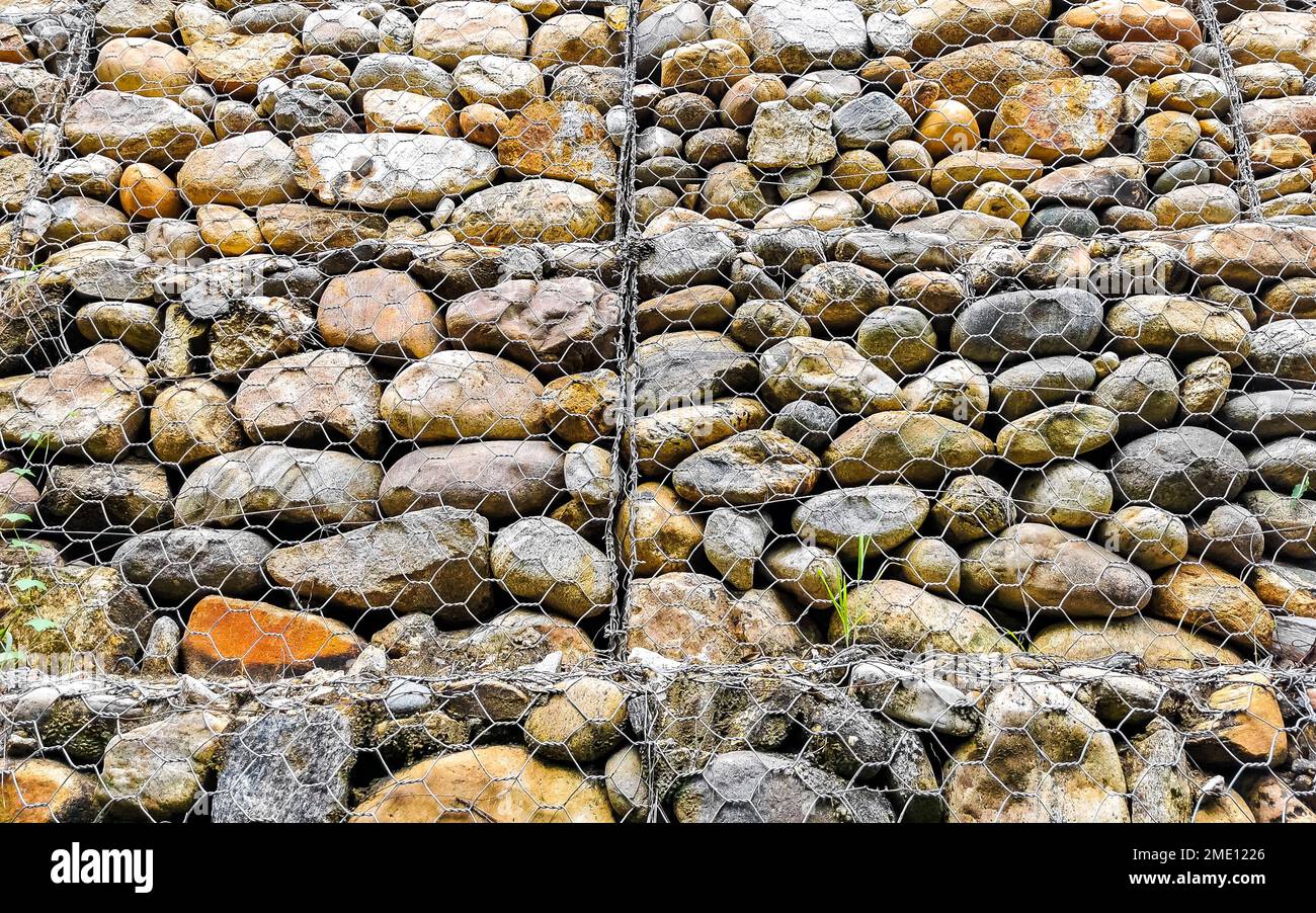 Stones rocks pinned behind a net in Zicatela Puerto Escondido Oaxaca ...