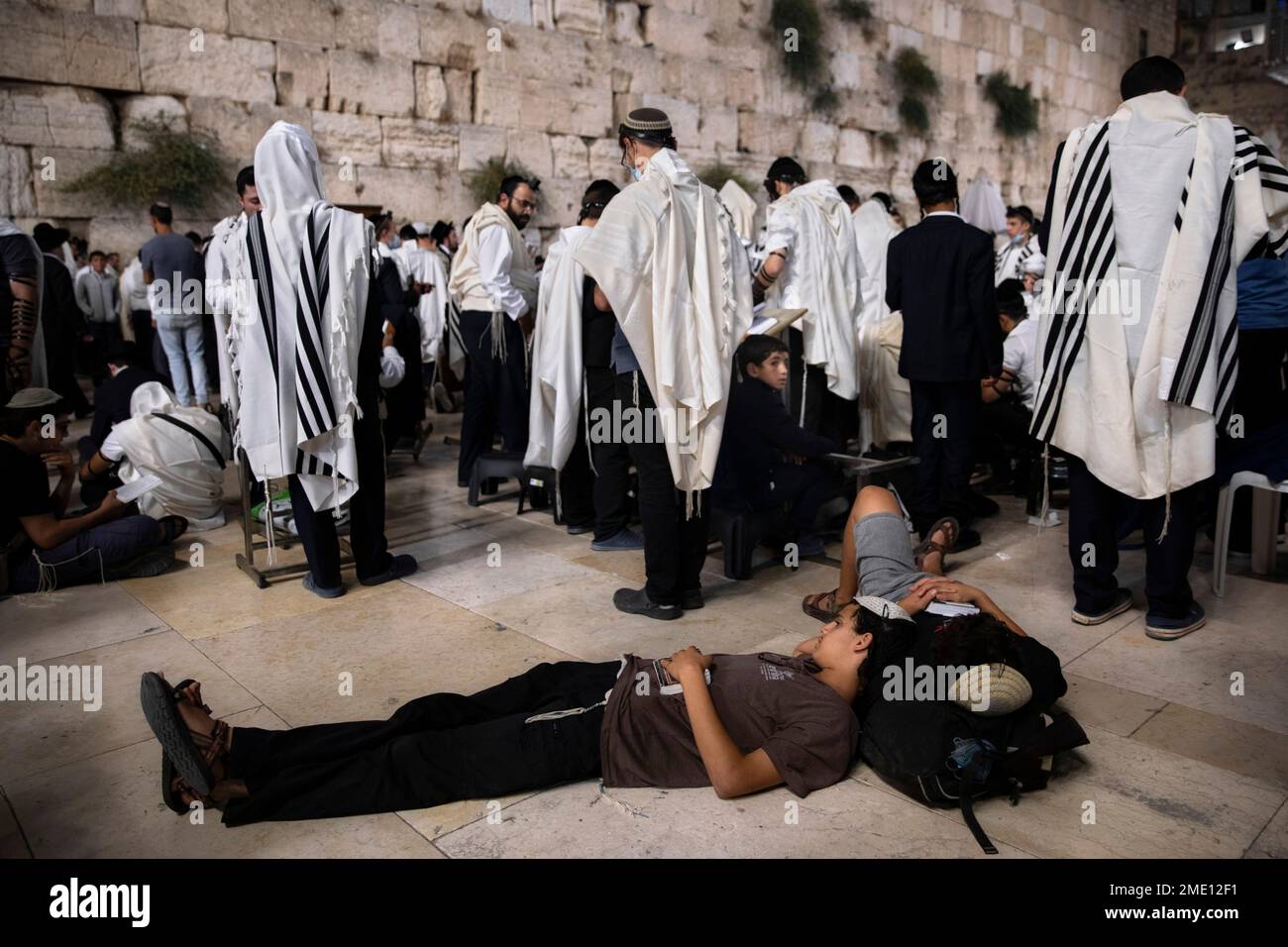 Ultra-Orthodox Jewish men pray as others sleep during the mourning ...