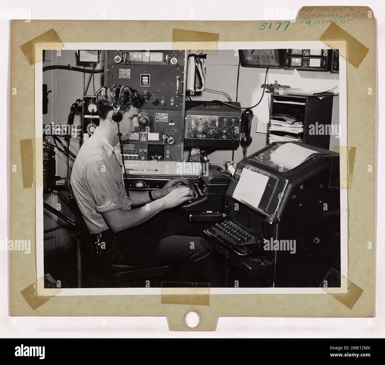 A Coast Guard radioman is seen operating communications equipment ...