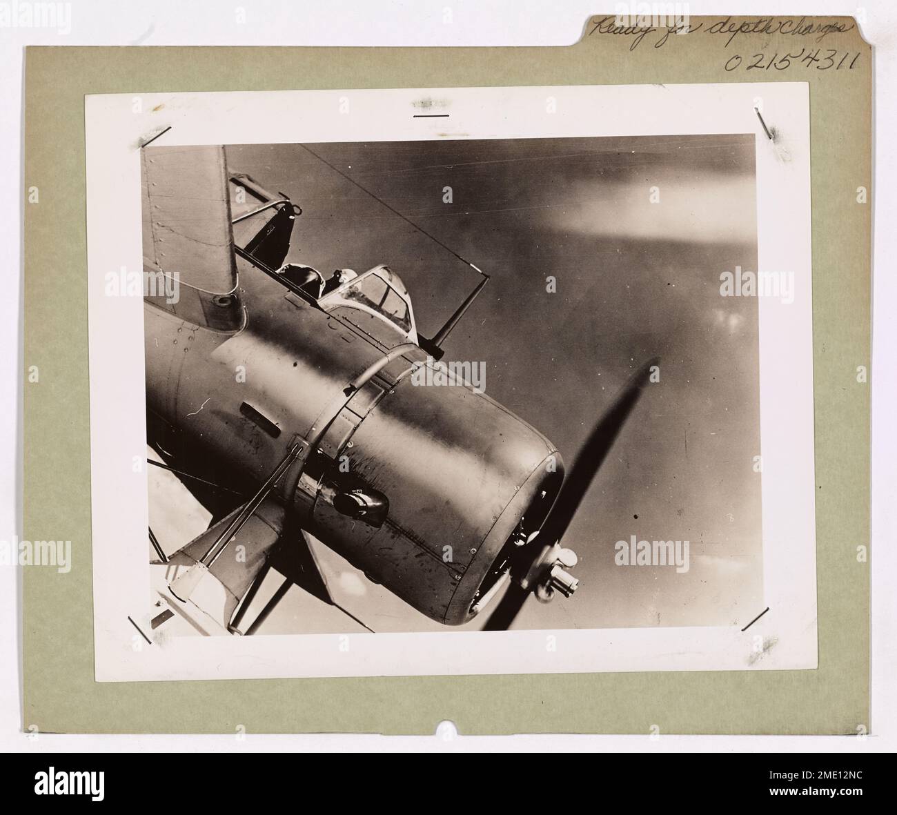 A pilot is seen in a running aircraft, preparing for a depth charge ...