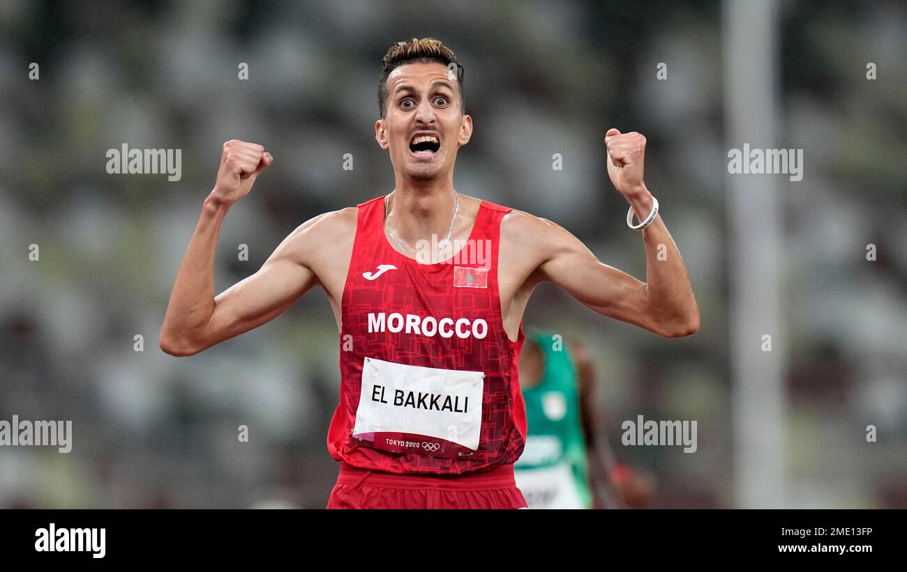 Soufiane El Bakkali, of Morocco, celebrates as he crosses the finish ...