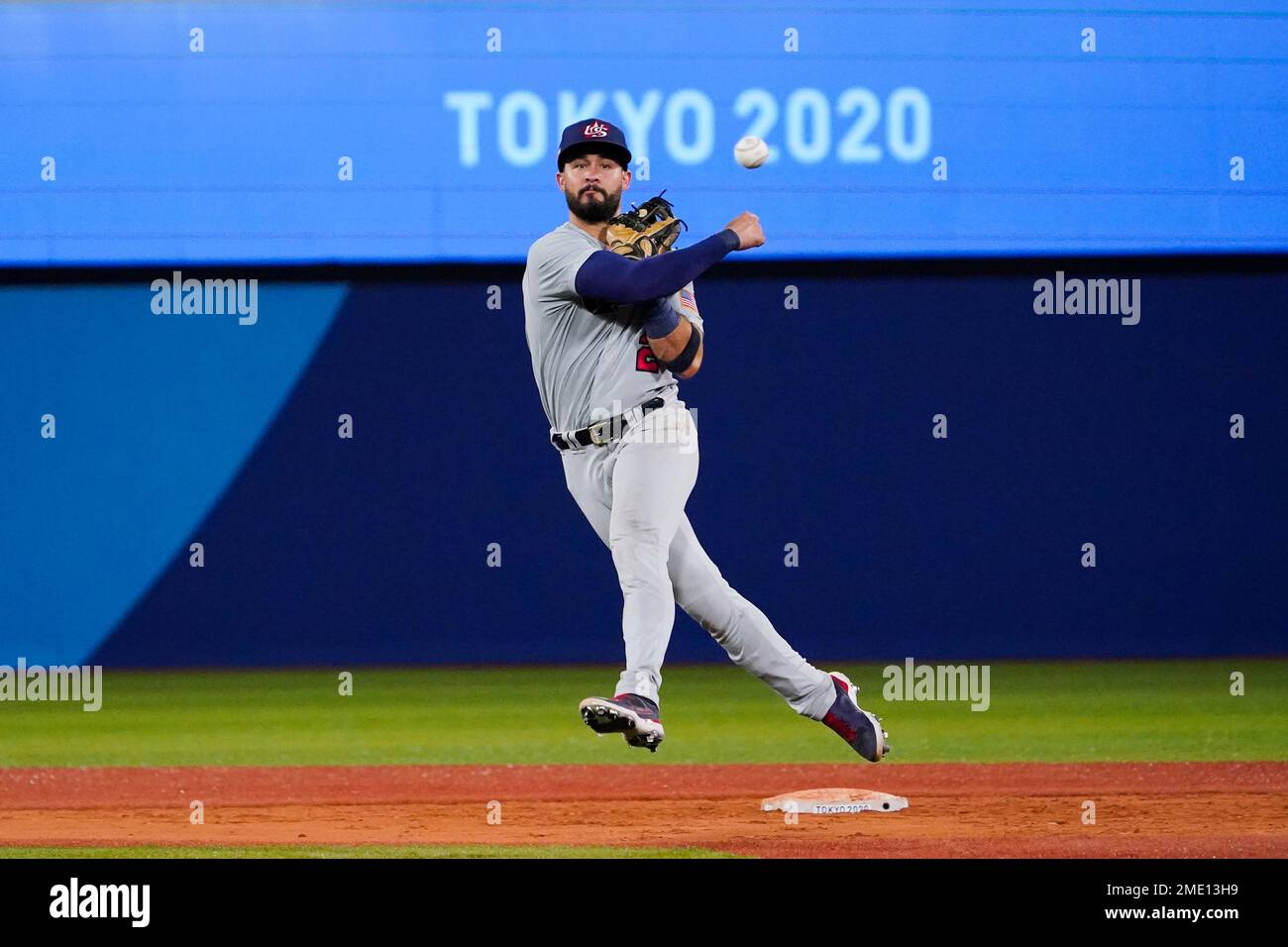 United States infielder Eddy Alvarez throws out Japan's Kensuke Kondoh ...